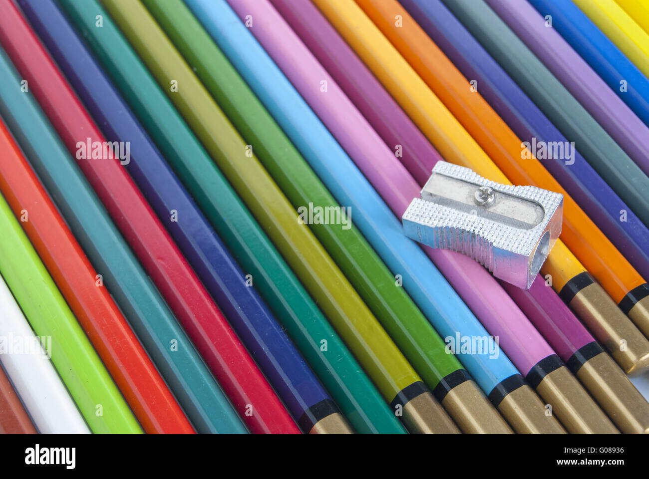 Used grunge color pencils with sharpener as backgr Stock Photo - Alamy