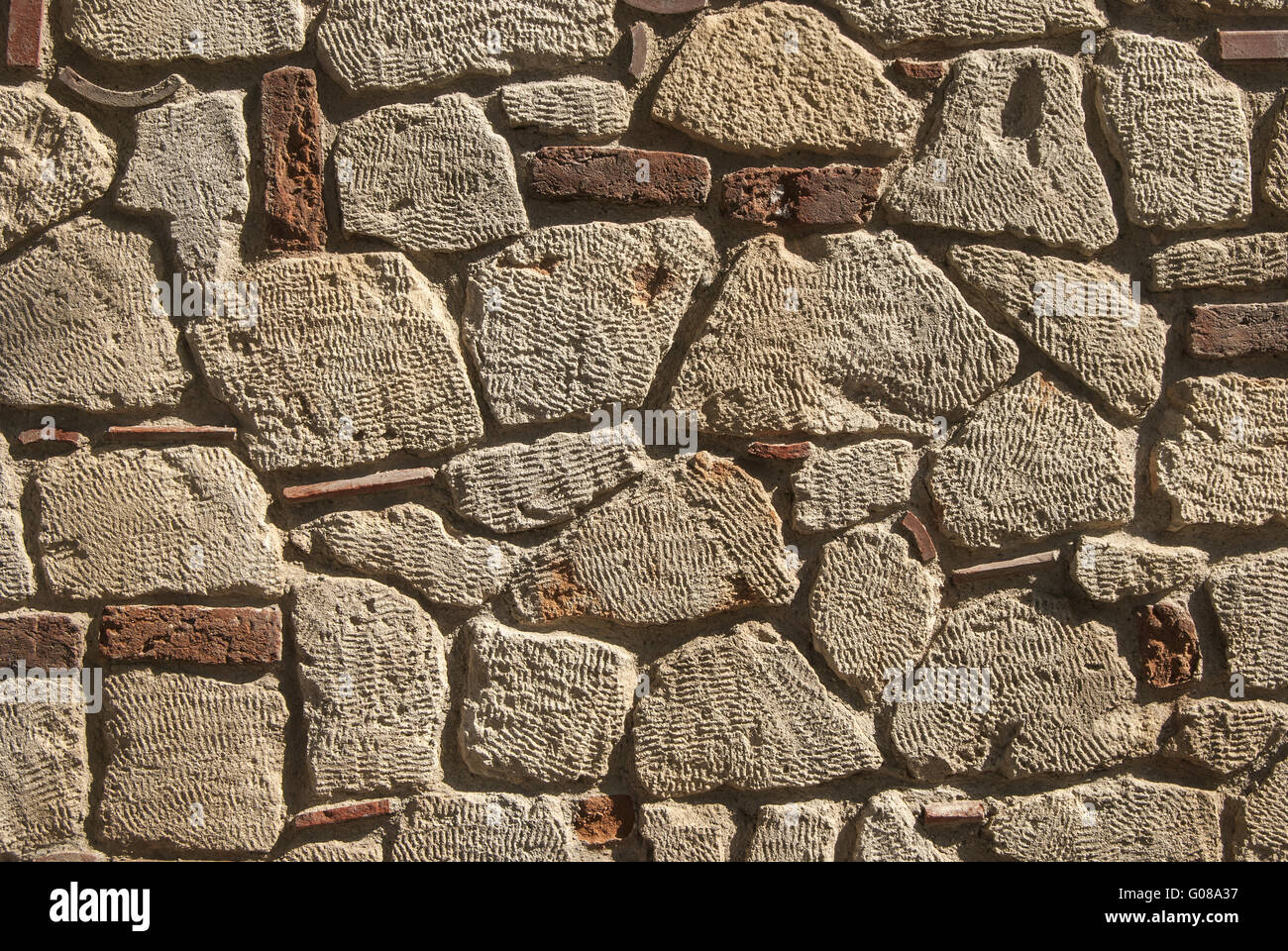 Masonry sandstone wall irregularly shaped stones a Stock Photo - Alamy