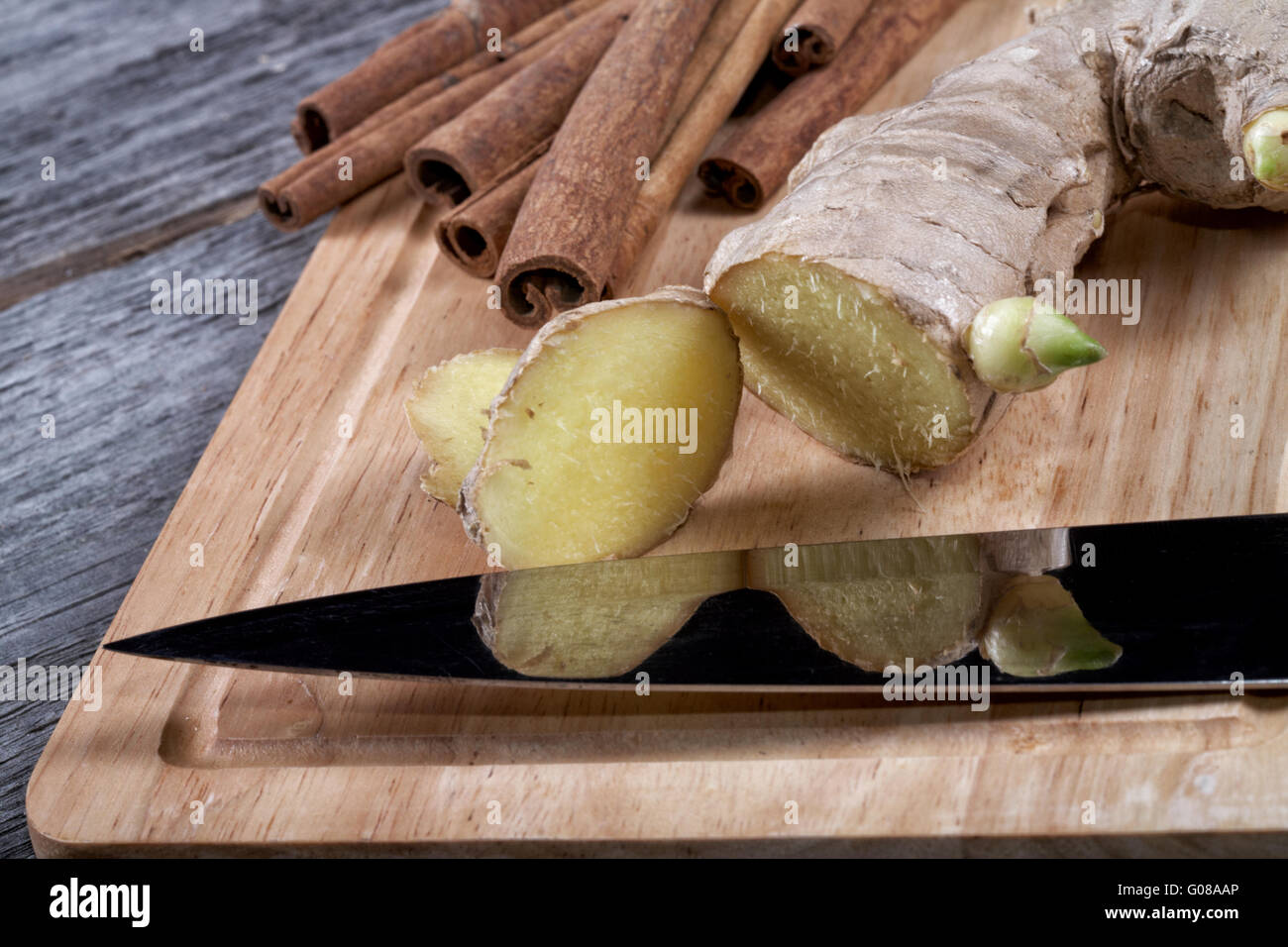 Kitchen knife ginger cinnamon on a chopping board Stock Photo - Alamy