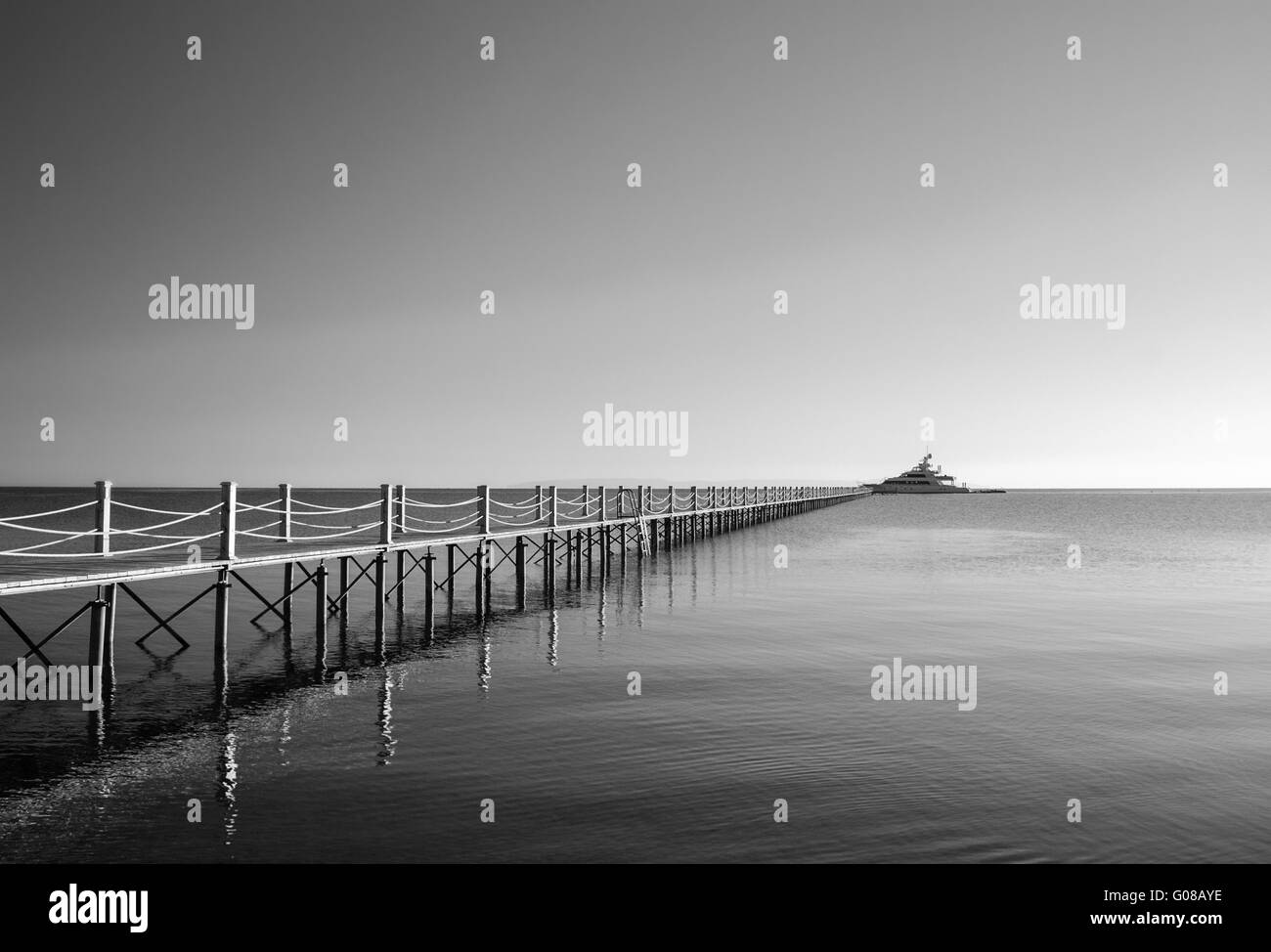 Tranquil beach pier sunset Black and White Stock Photos & Images - Alamy