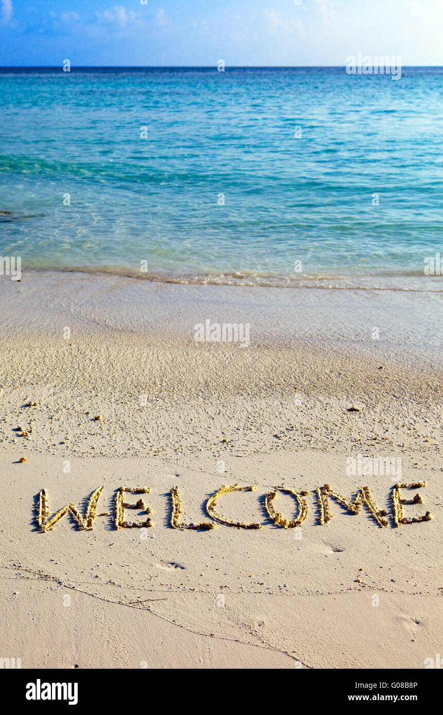 Word welcome is written on sand on oceanside Stock Photo - Alamy