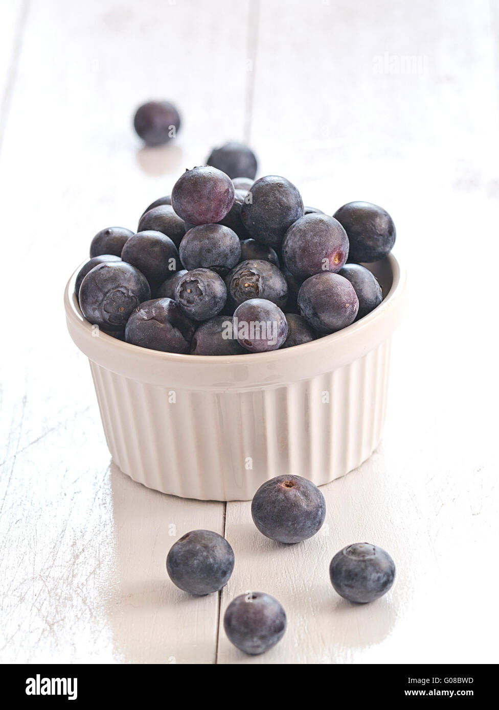 Fresh huckleberries in a bowl on a white wood tray Stock Photo - Alamy
