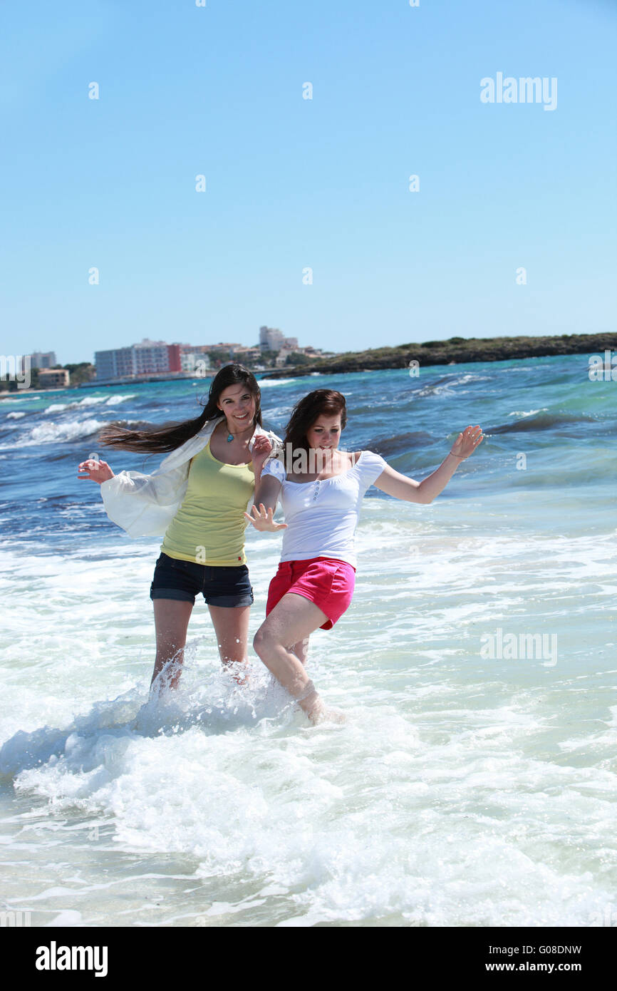 Two women frolicking in the sea Stock Photo - Alamy