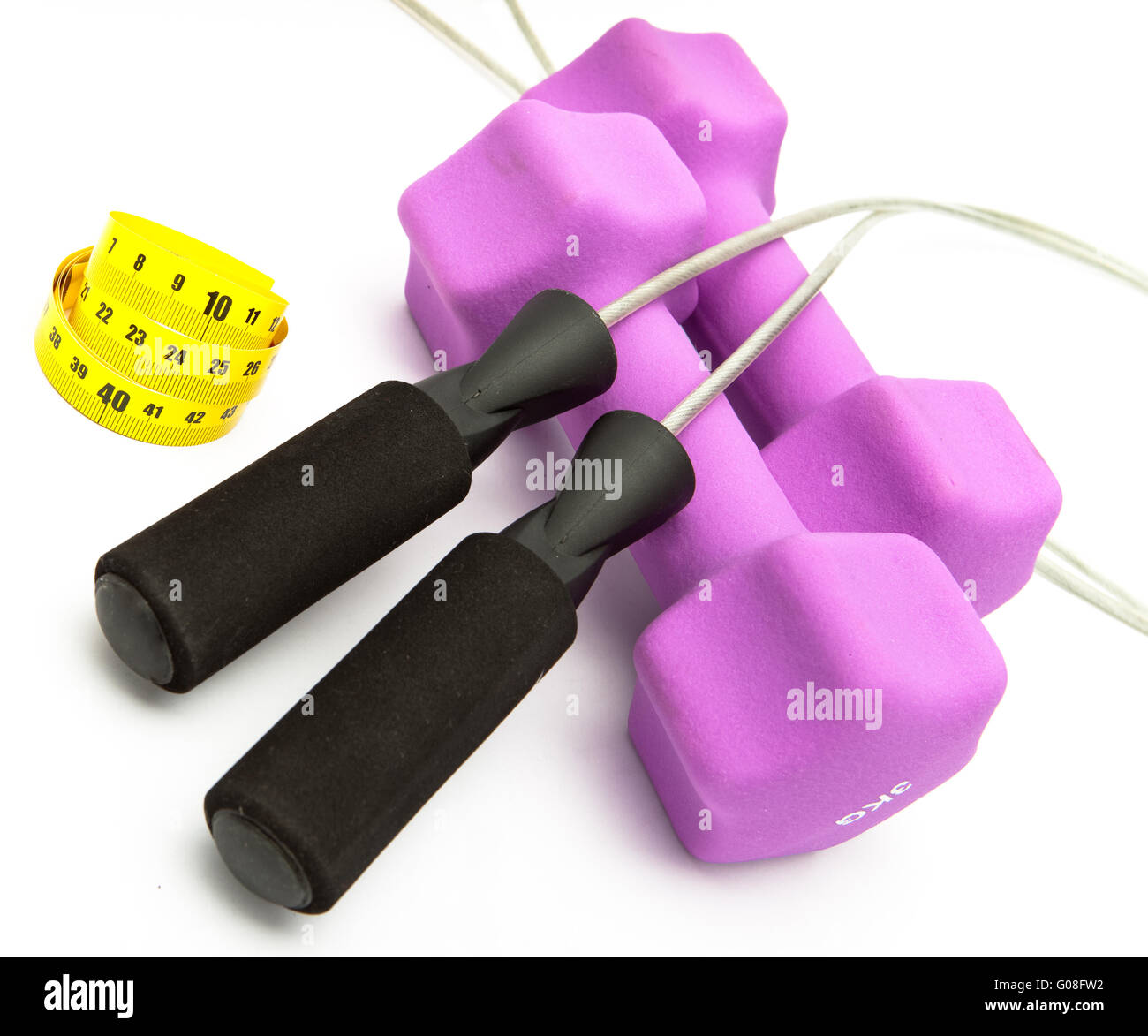 Skipping rope, measuring tape and and Pink dumbbel Stock Photo - Alamy
