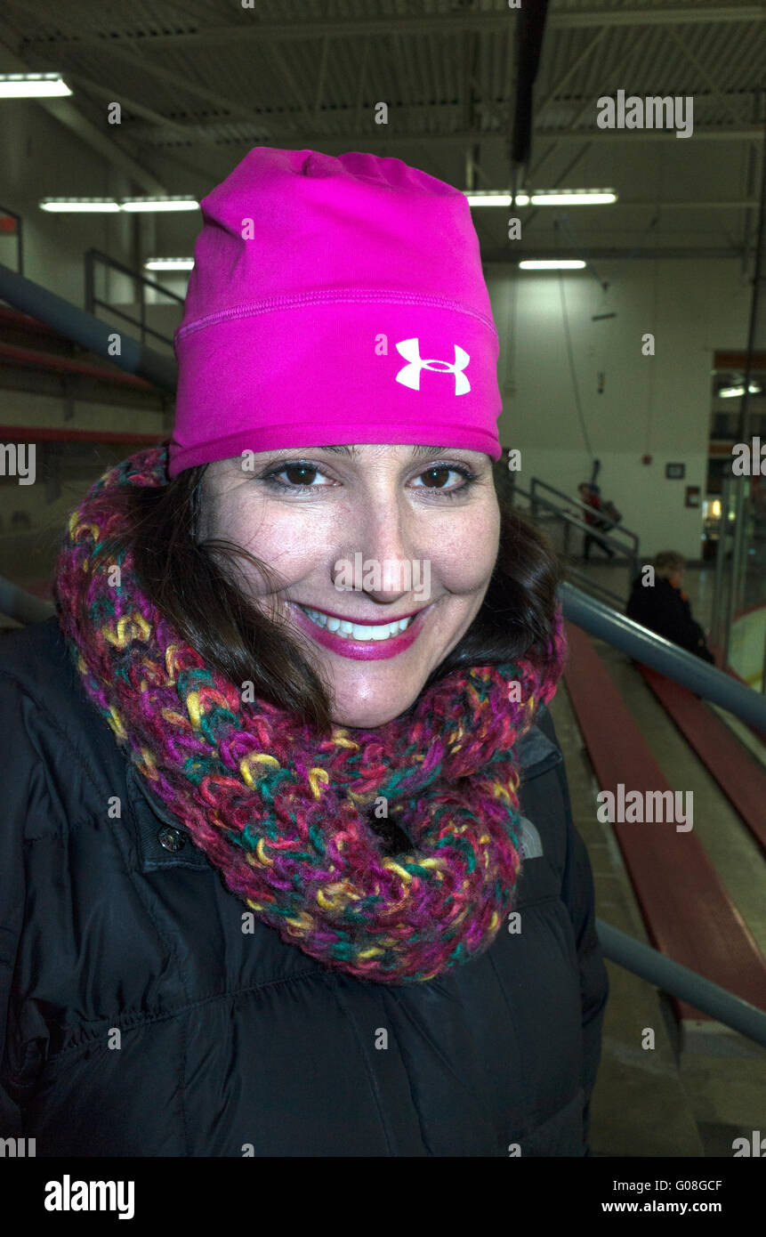 Woman spectator age 48 dressed warmly to watch son's indoor hockey game ...