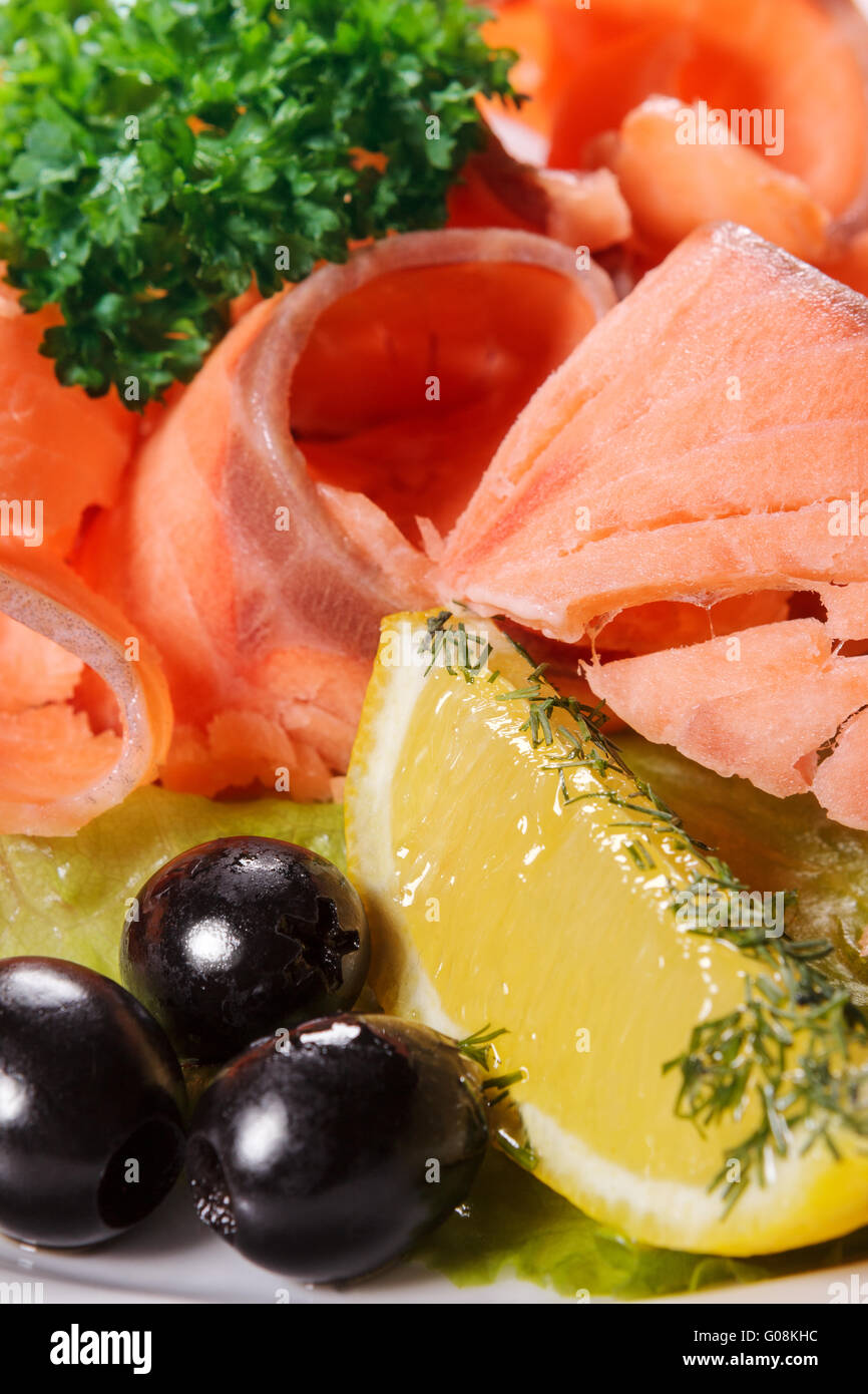Slices of tasty fish with spices on dish Stock Photo - Alamy