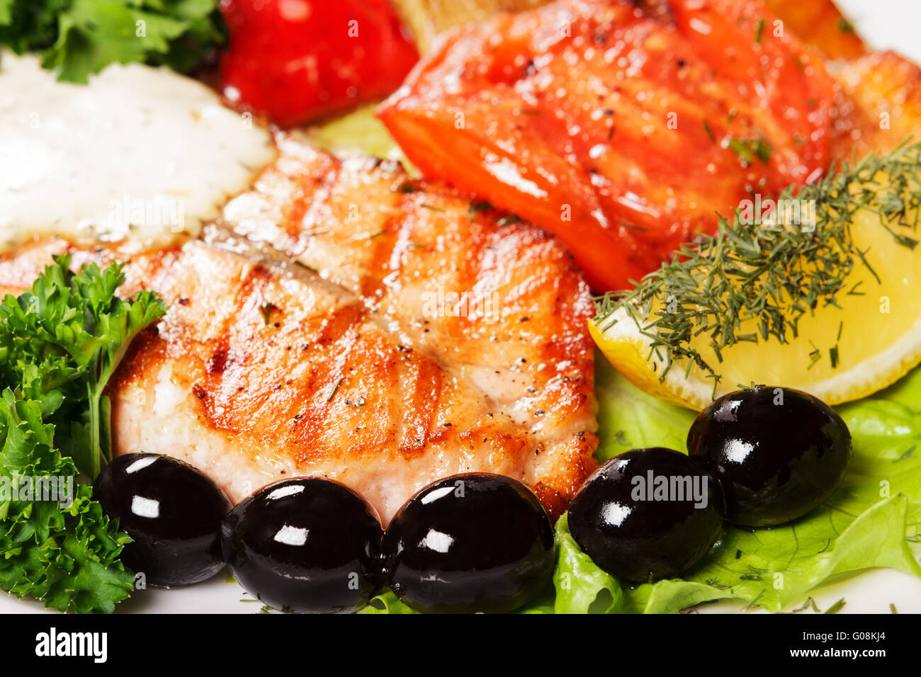 Tasty and appetizing fish grill with olives Stock Photo - Alamy