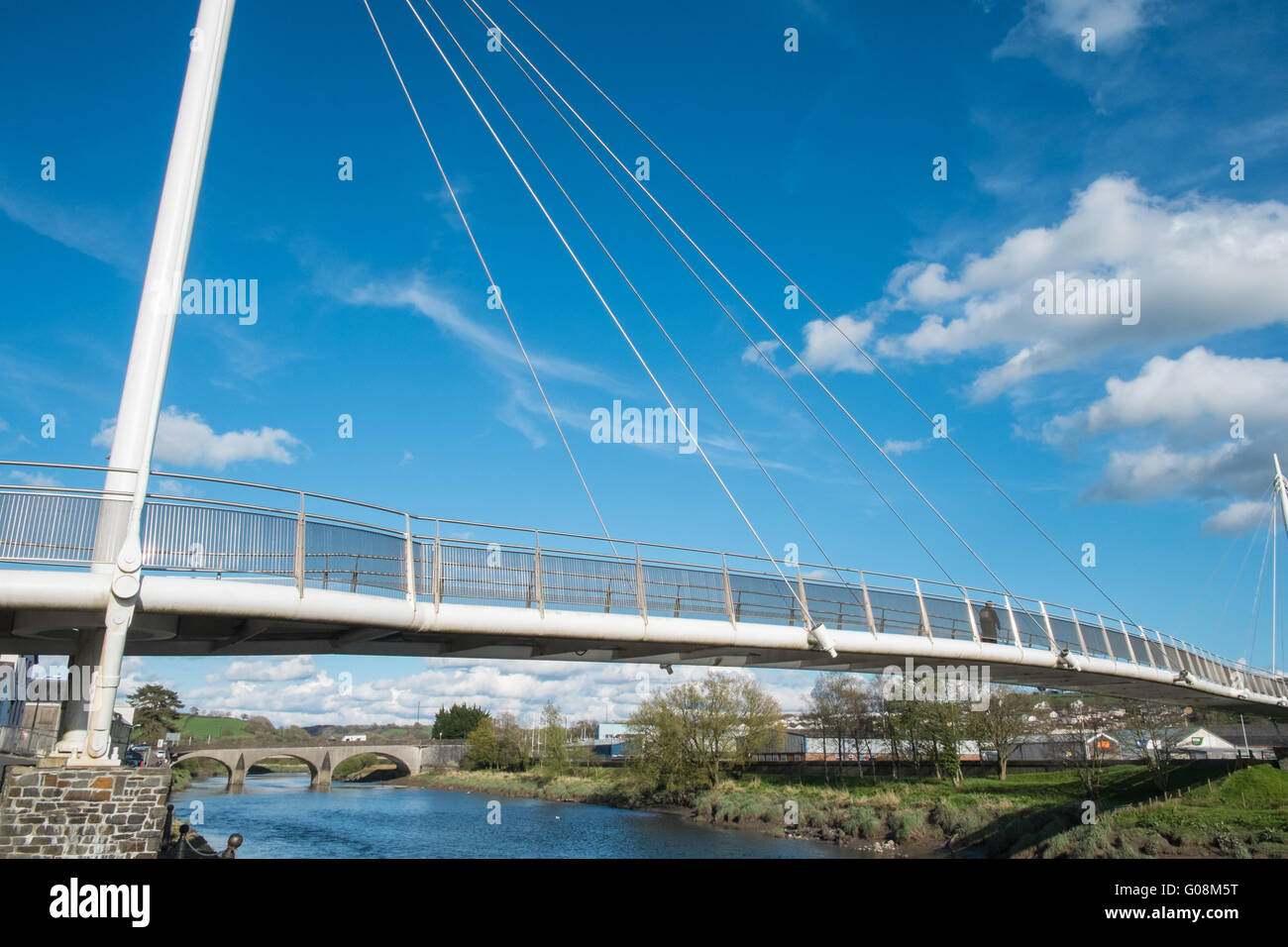 Modern bridge,a footbridge over River Towy,linking train station to ...