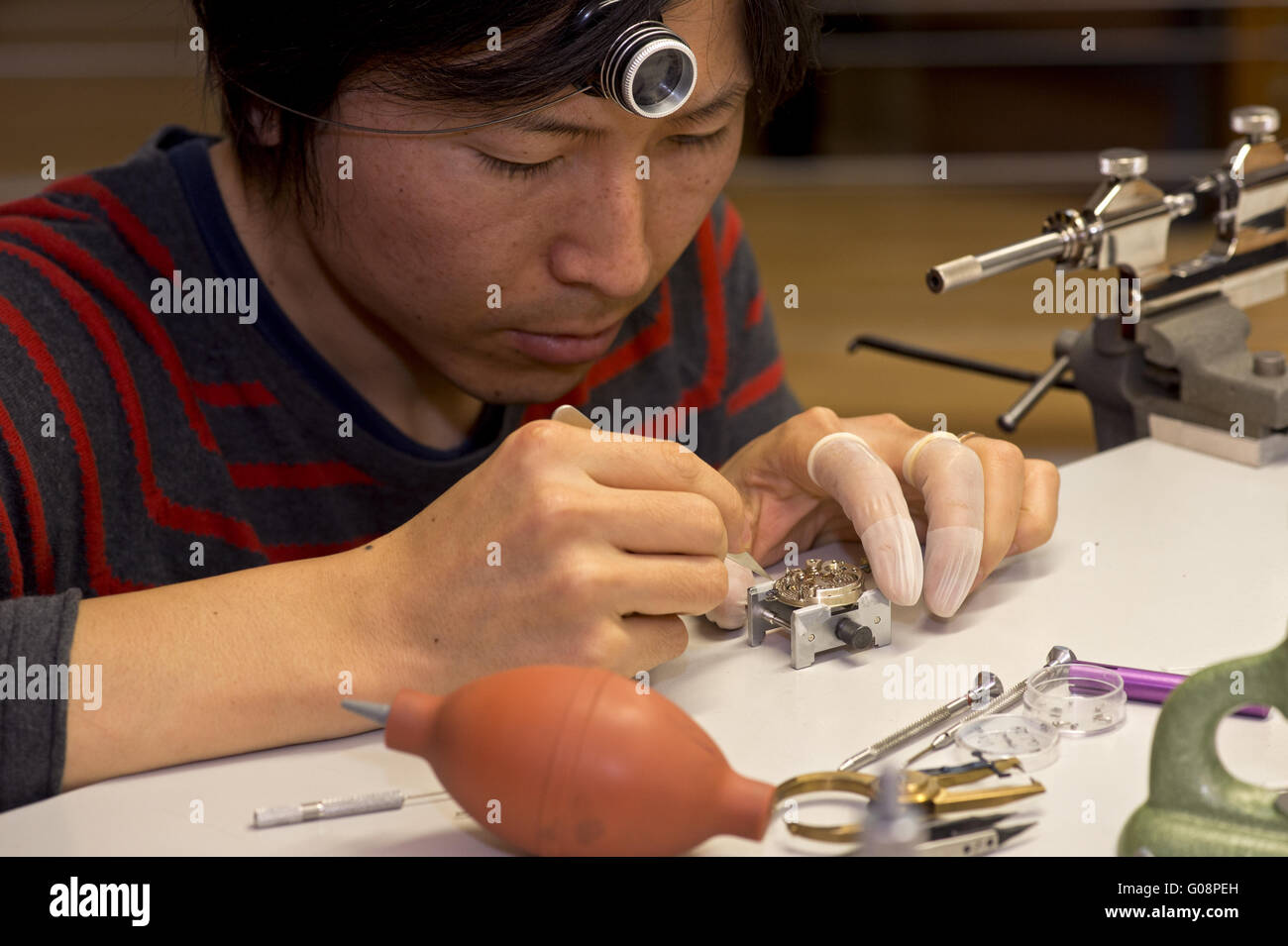 Watchmaker assembling a wristwatch Stock Photo - Alamy