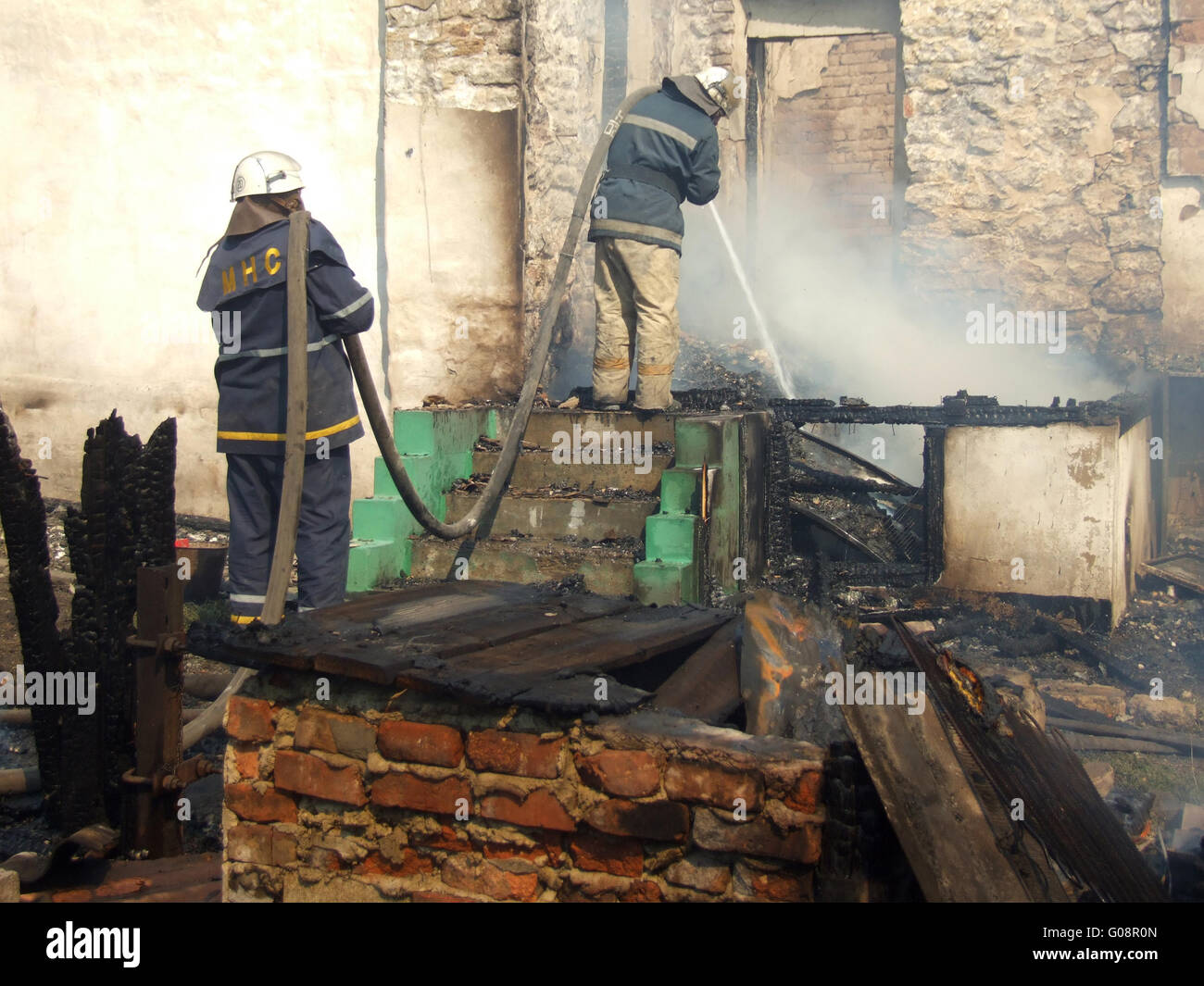 fireman spraying water firefighters extinguish a fire in an apartment ...