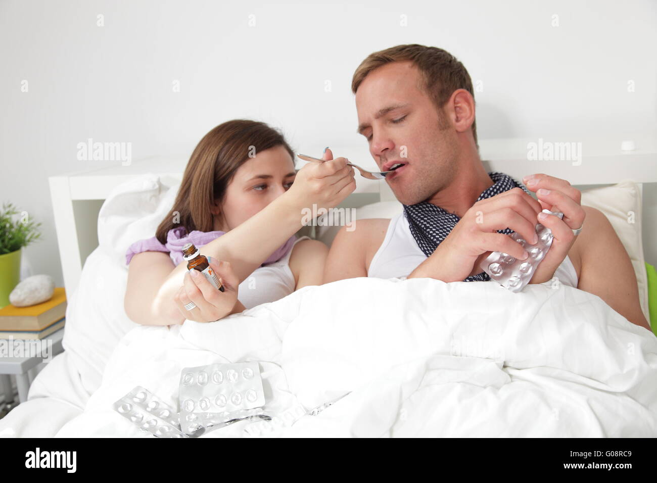 Sick married couple in bed Stock Photo - Alamy