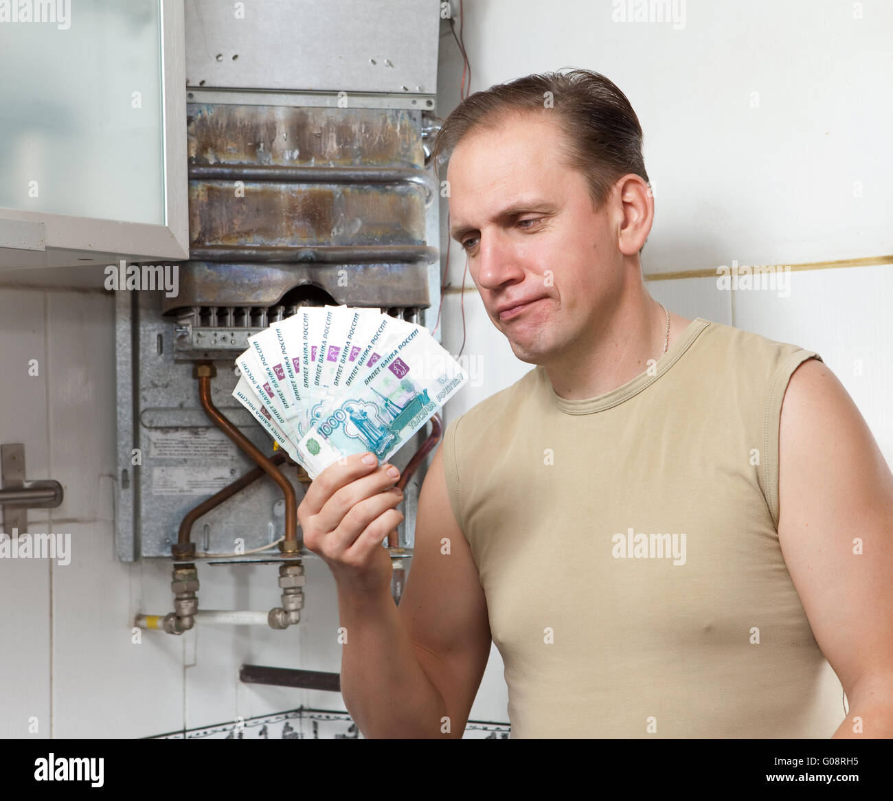 man counts money for repair of a gas water heater Stock Photo - Alamy