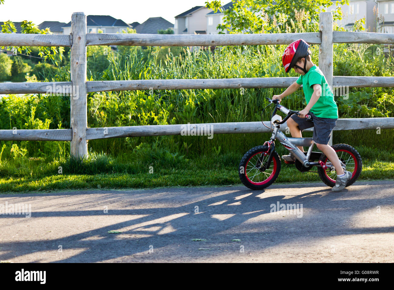 Child bicycling on the bike path in the park Stock Photo - Alamy