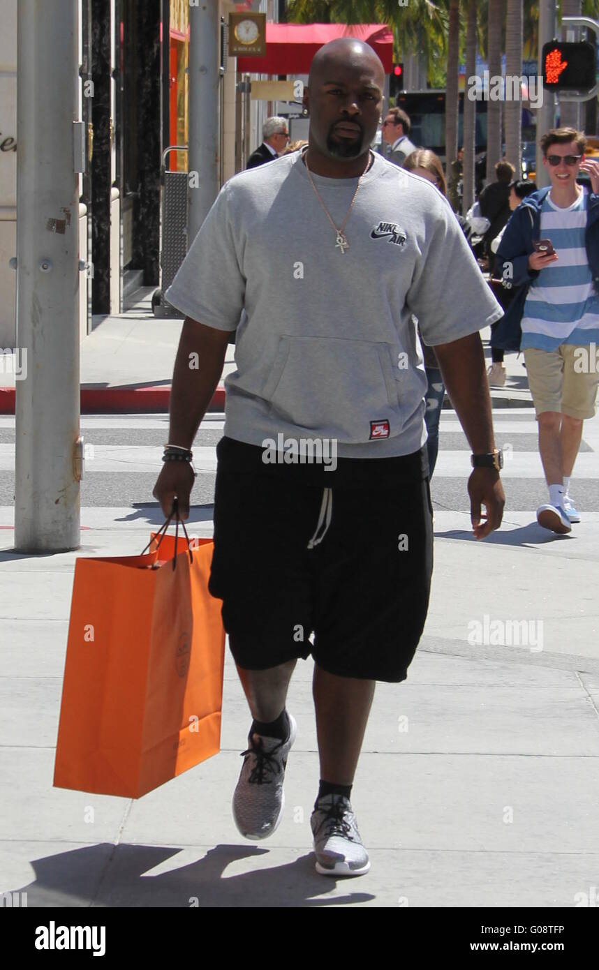 Corey Gamble carries a Hermes shopping bag on Rodeo Drive Featuring ...