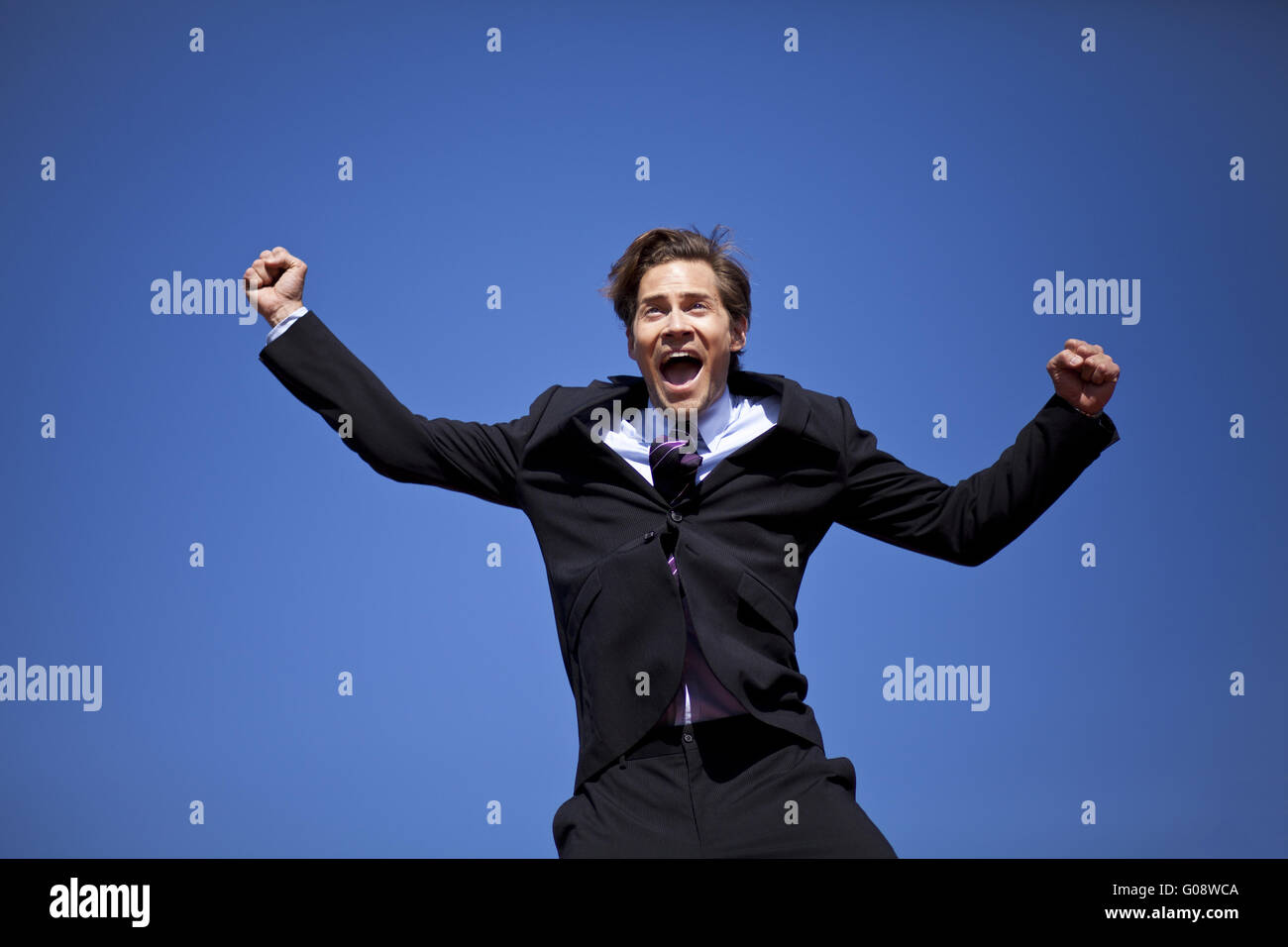 Excited businessman jumping hi-res stock photography and images - Alamy