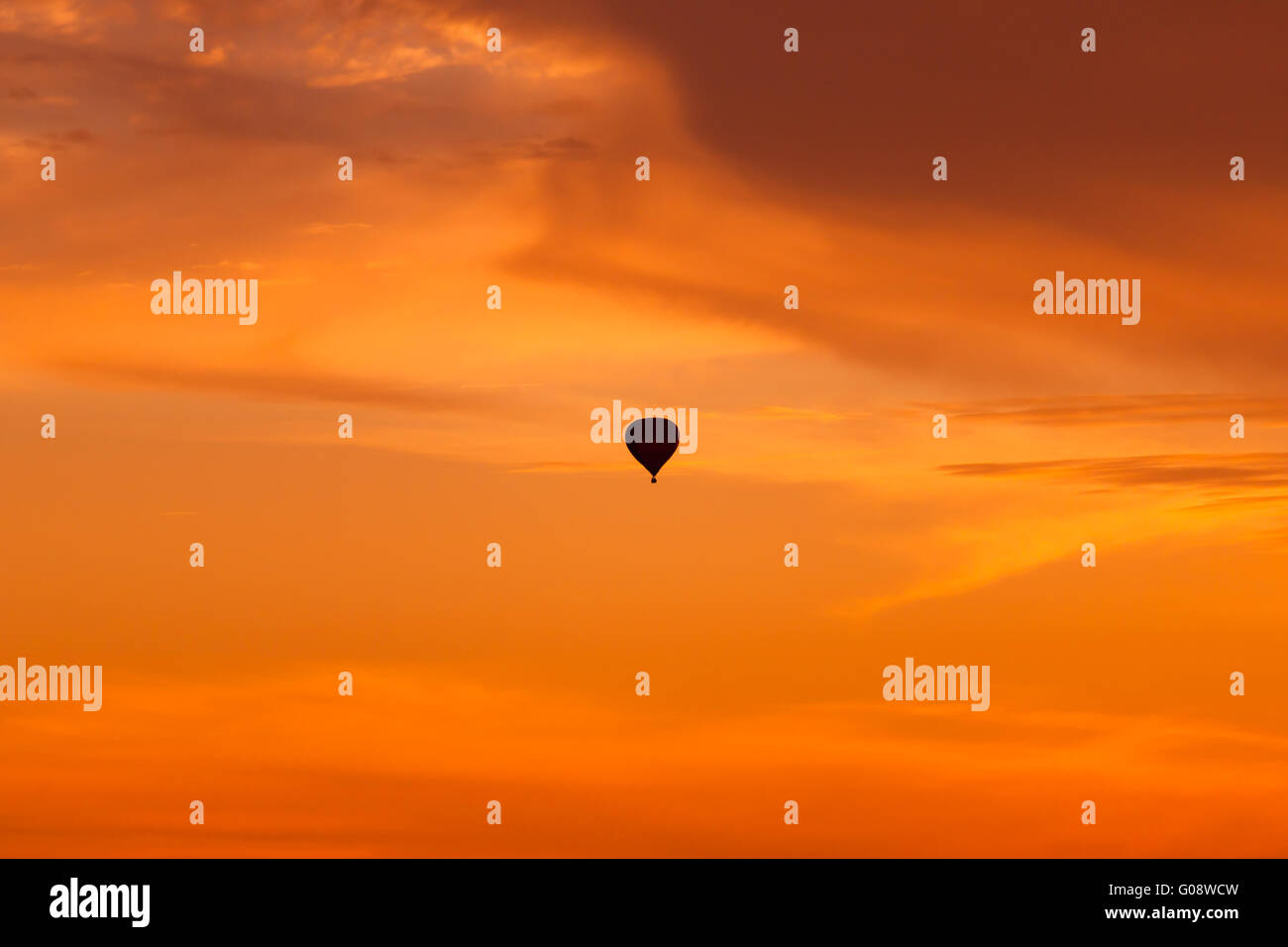 Hot air balloon flying at sunset sky Stock Photo - Alamy