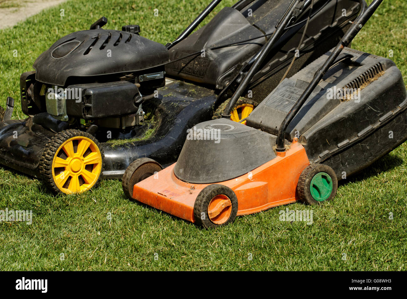 two lawnmower in the garden lawn the grass (fuel and electricity Stock ...