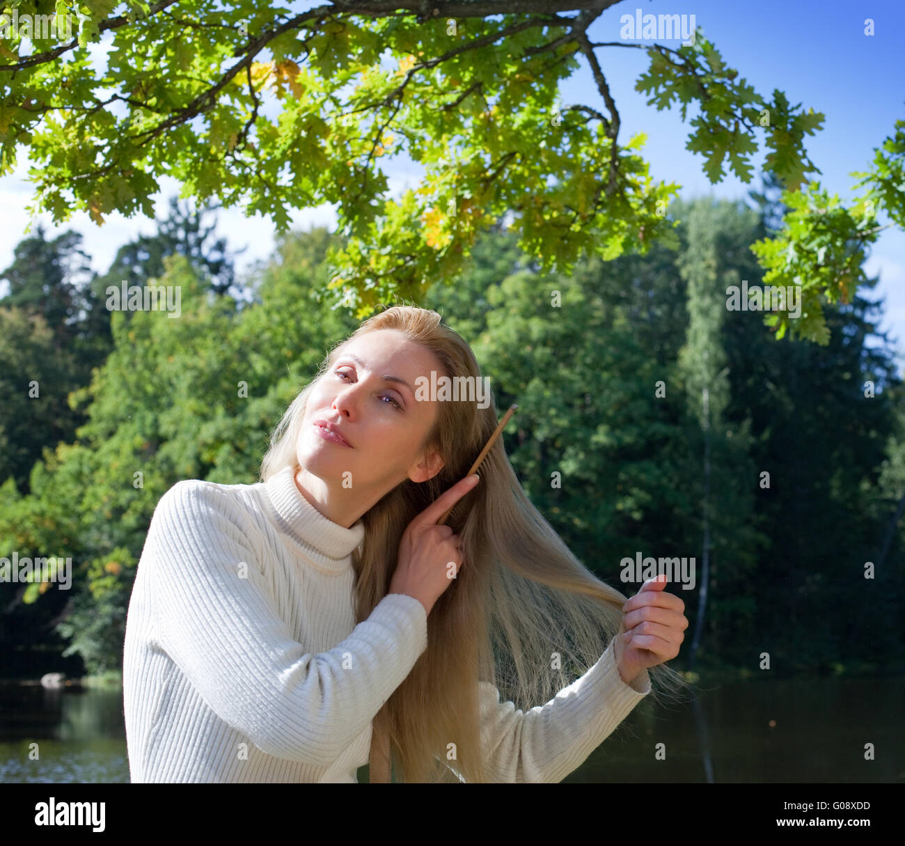 beautiful woman combs long hair in the summer day Stock Photo - Alamy