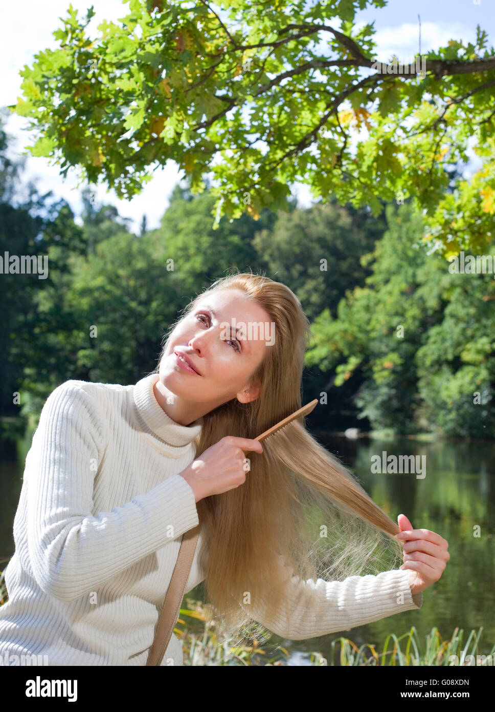 beautiful woman combs long hair in the summer day Stock Photo - Alamy