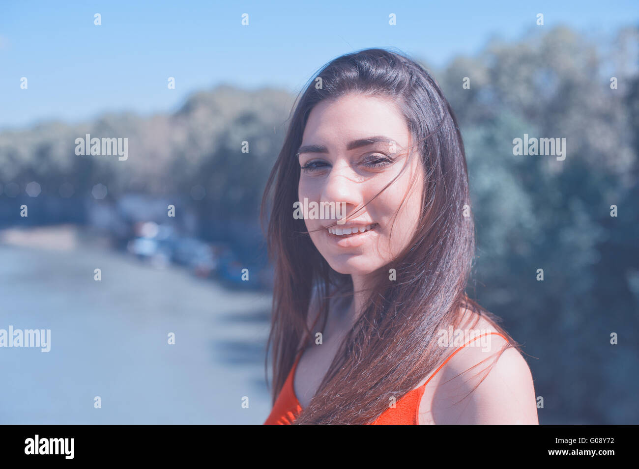 Young woman outdoor summer relaxed portrait river out of focus in ...