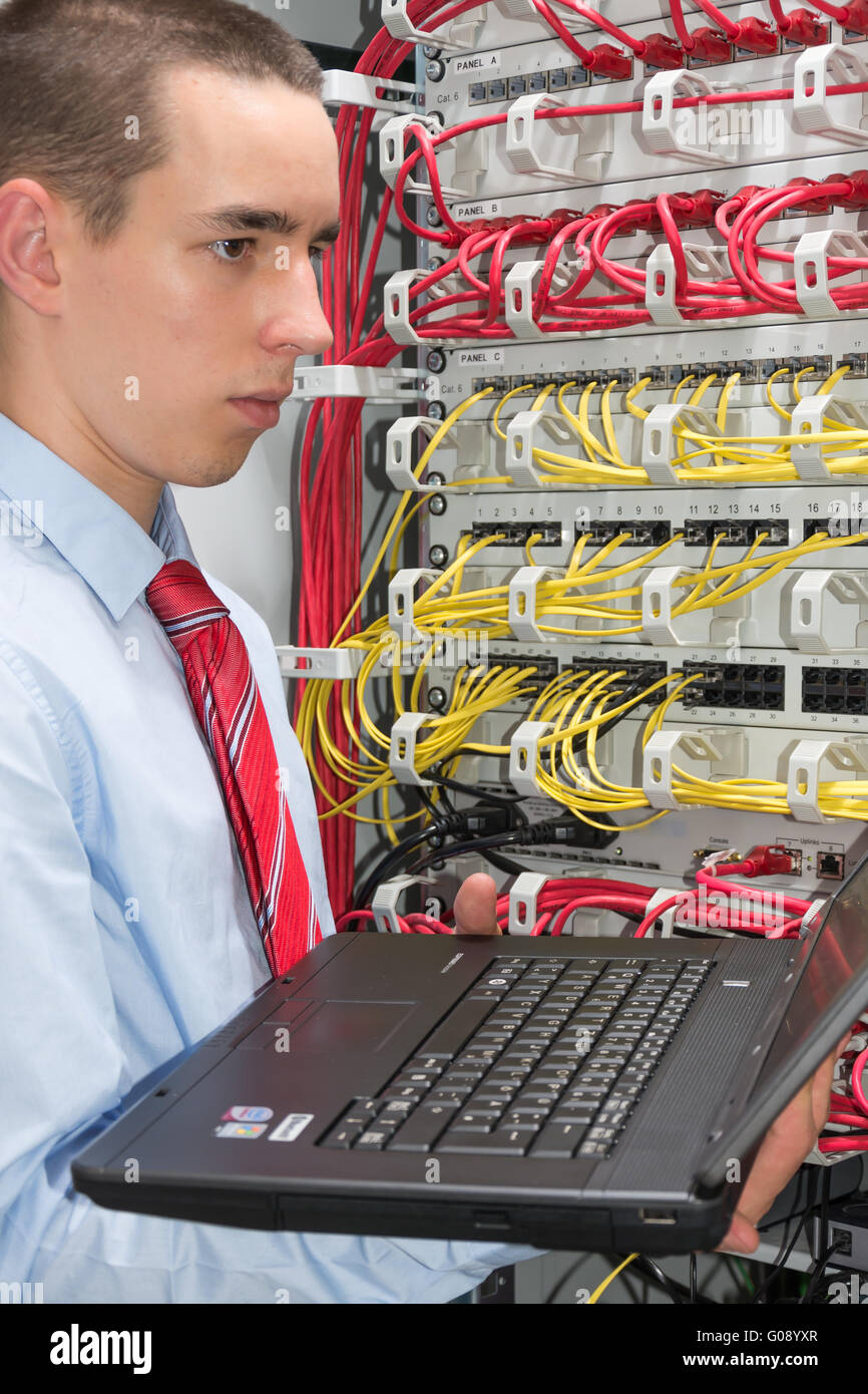 young it engineer in network server room Stock Photo - Alamy