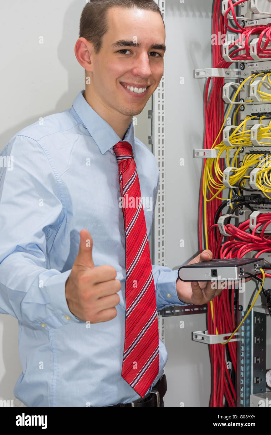 young it engineer in network server room Stock Photo - Alamy