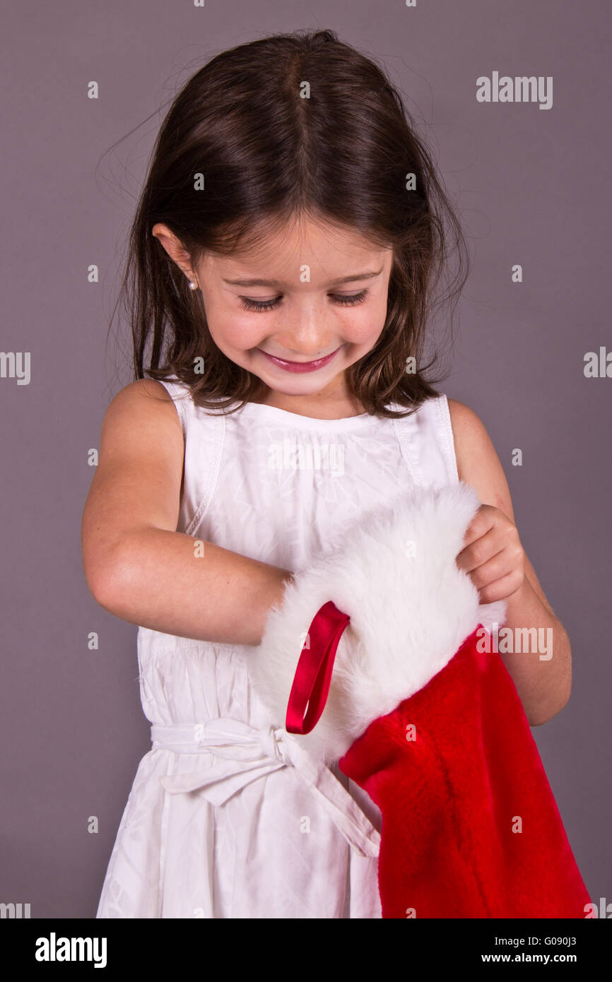 Little girl getting a gift from her Christmas stocking Stock Photo - Alamy