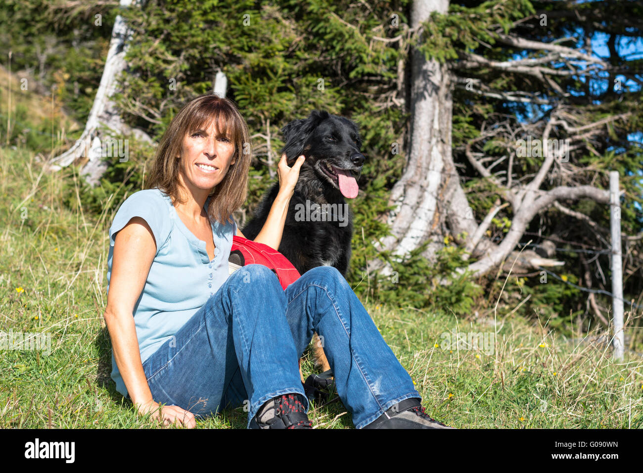 Woman having a break while hiking Stock Photo - Alamy