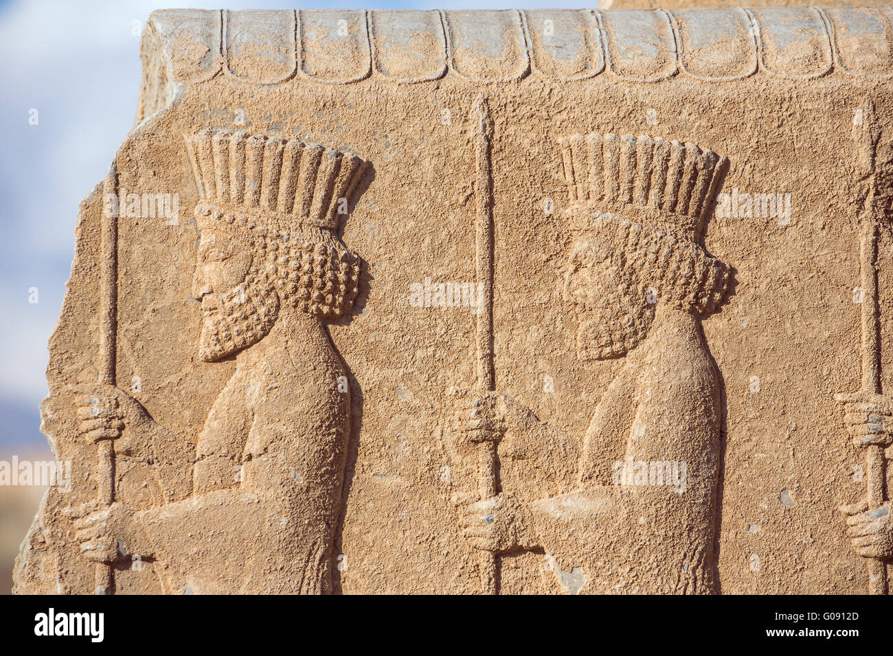Soldiers of historical empire with weapon in hands. Stone bas-relief in ...