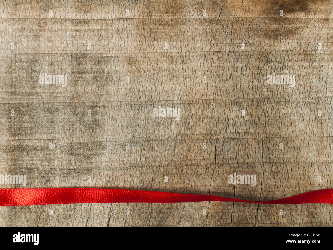 Red ribbon for gift wrap on wooden background Stock Photo - Alamy