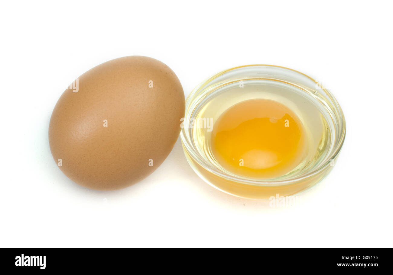 One whole egg and another broken in half raw egg Stock Photo - Alamy