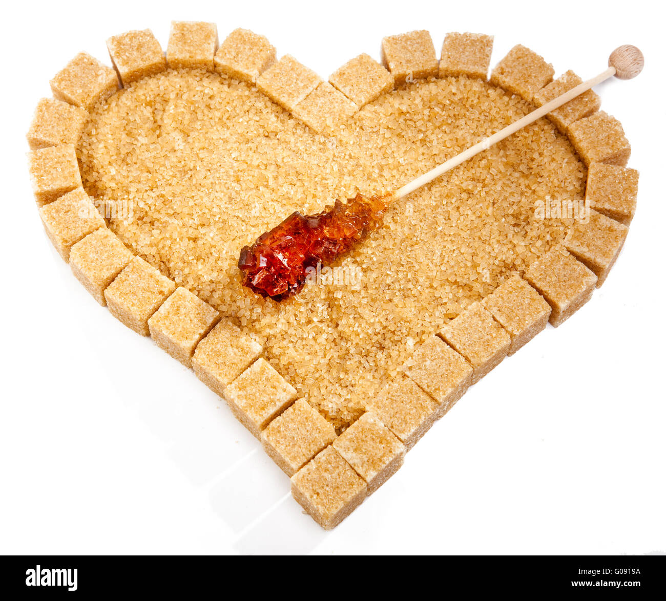 Heart from not refined reed sugar and candy sugar Stock Photo - Alamy