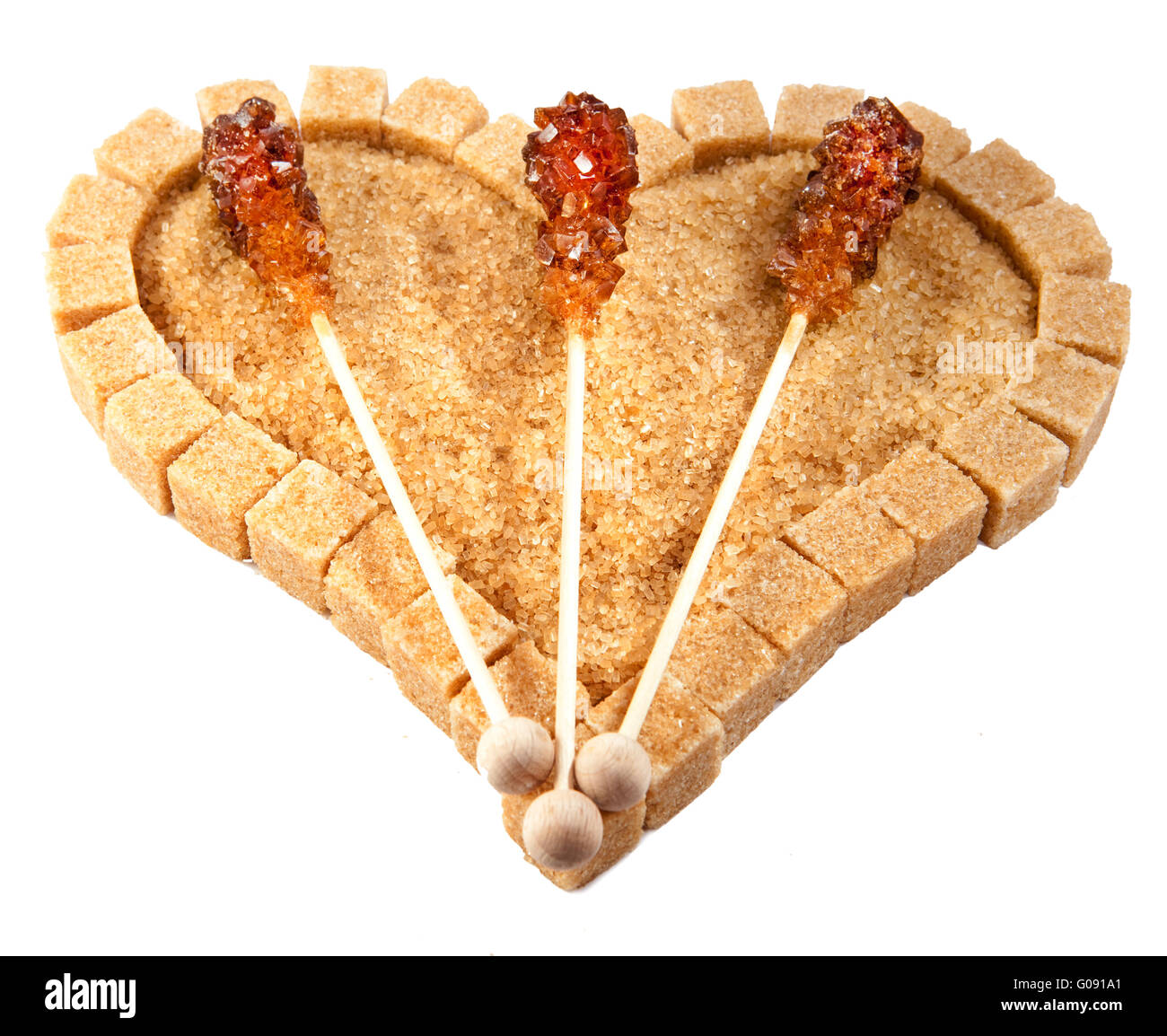 Heart from not refined reed sugar and candy sugar Stock Photo - Alamy