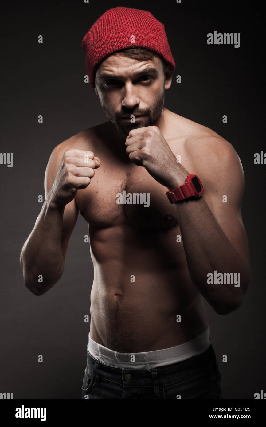Portrait of a fit young man in an aggressive pose Stock Photo - Alamy