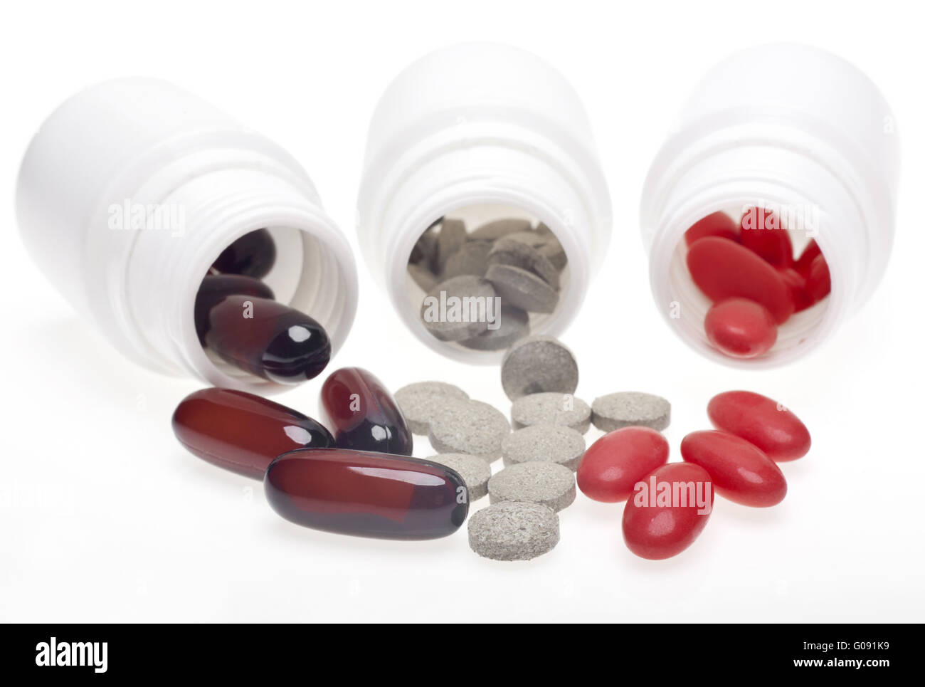 Spilled Capsules From White Bottles Stock Photo - Alamy
