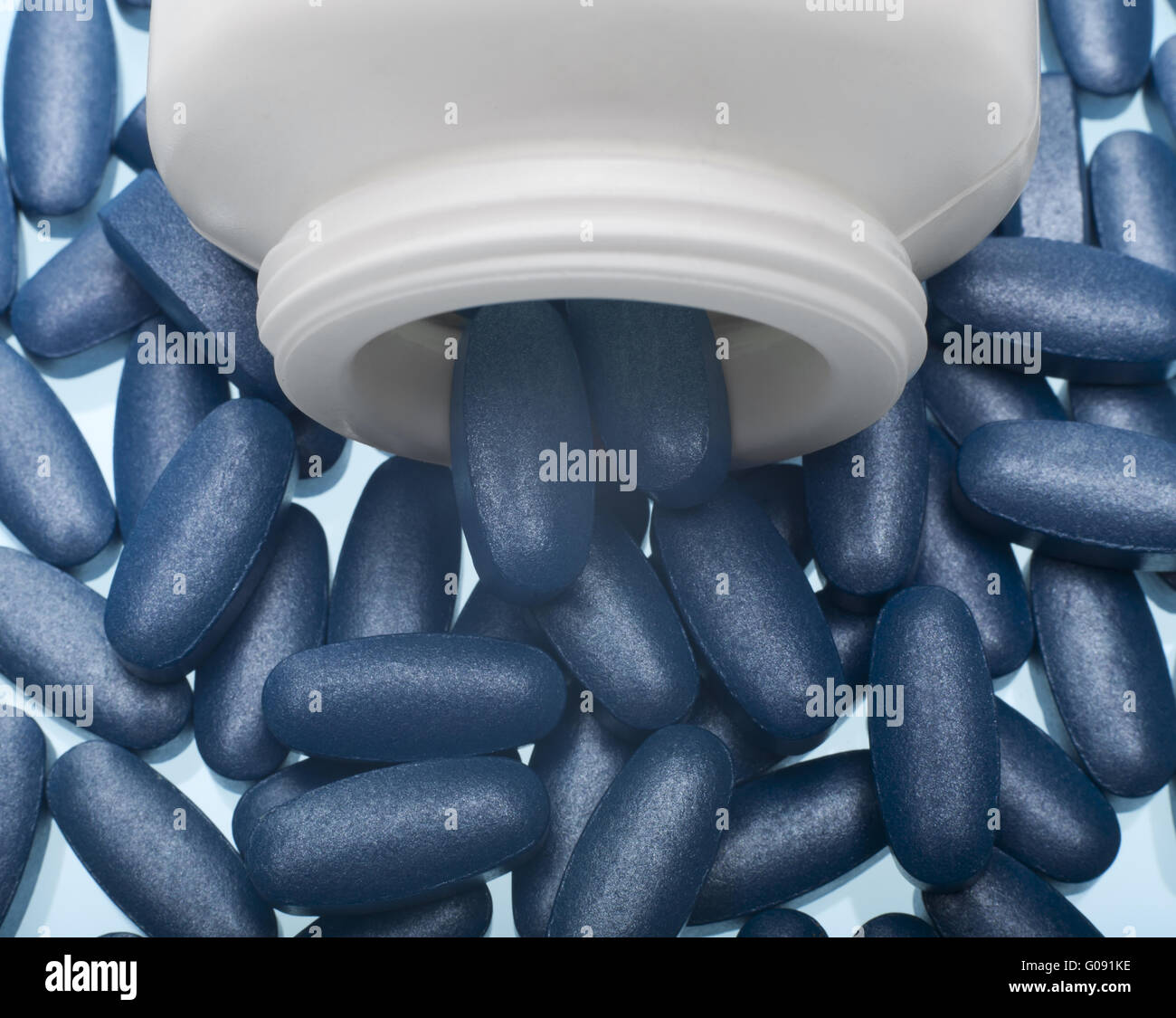 Spilled Capsules From White Bottles Stock Photo - Alamy