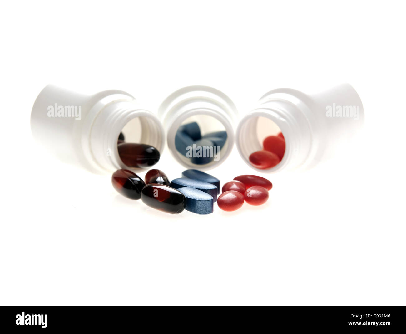 Spilled Capsules From White Bottles Stock Photo - Alamy