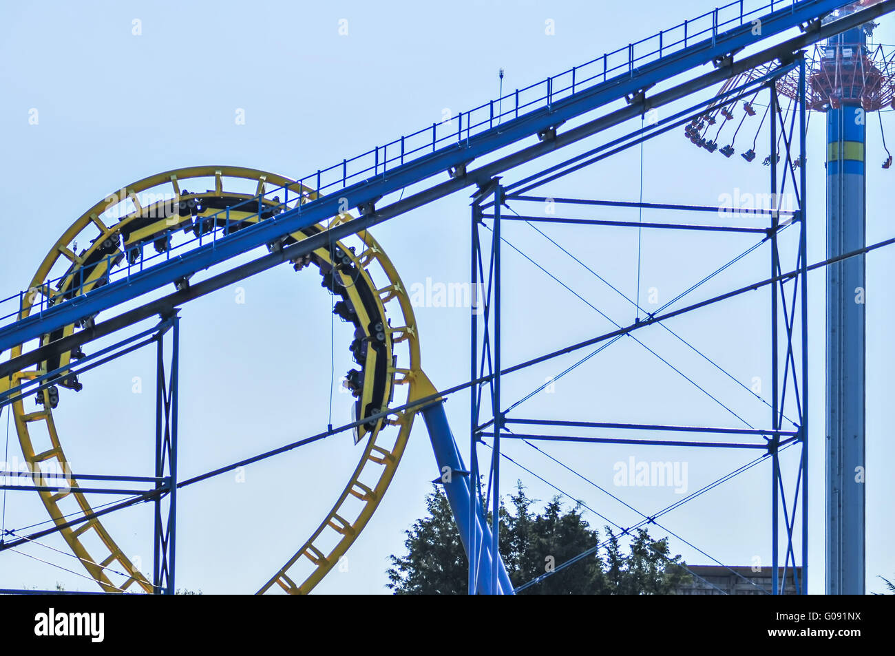 rollercoasters at an amusement park with blue sky Stock Photo - Alamy