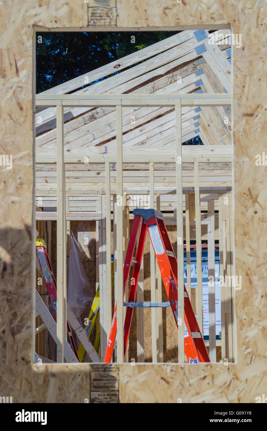 wood frame construction job seen trhough window opening Stock Photo - Alamy