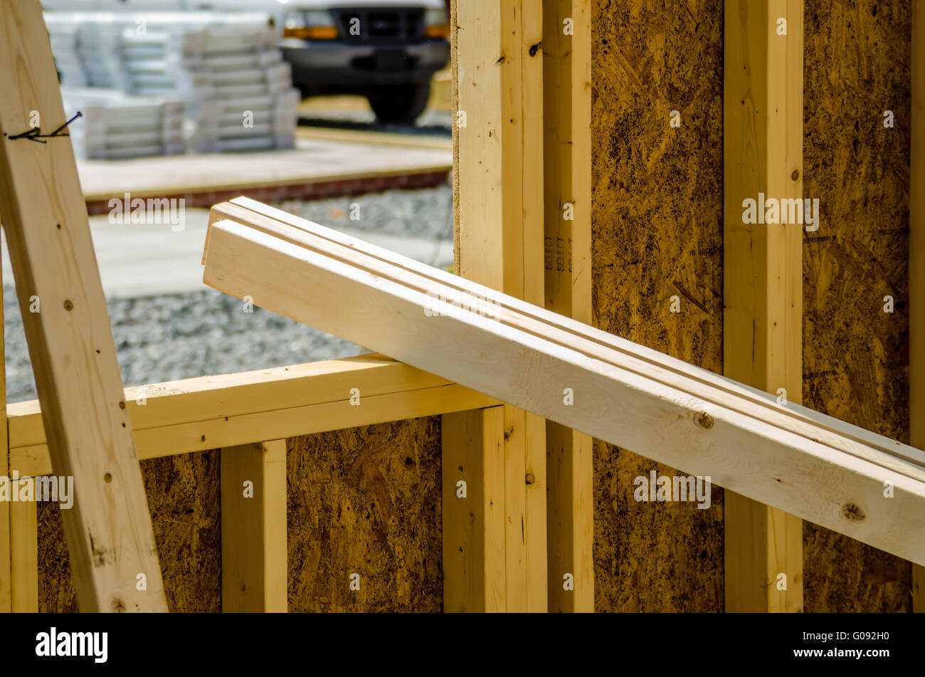 stack of wood stud planks at construction site resting on window ...
