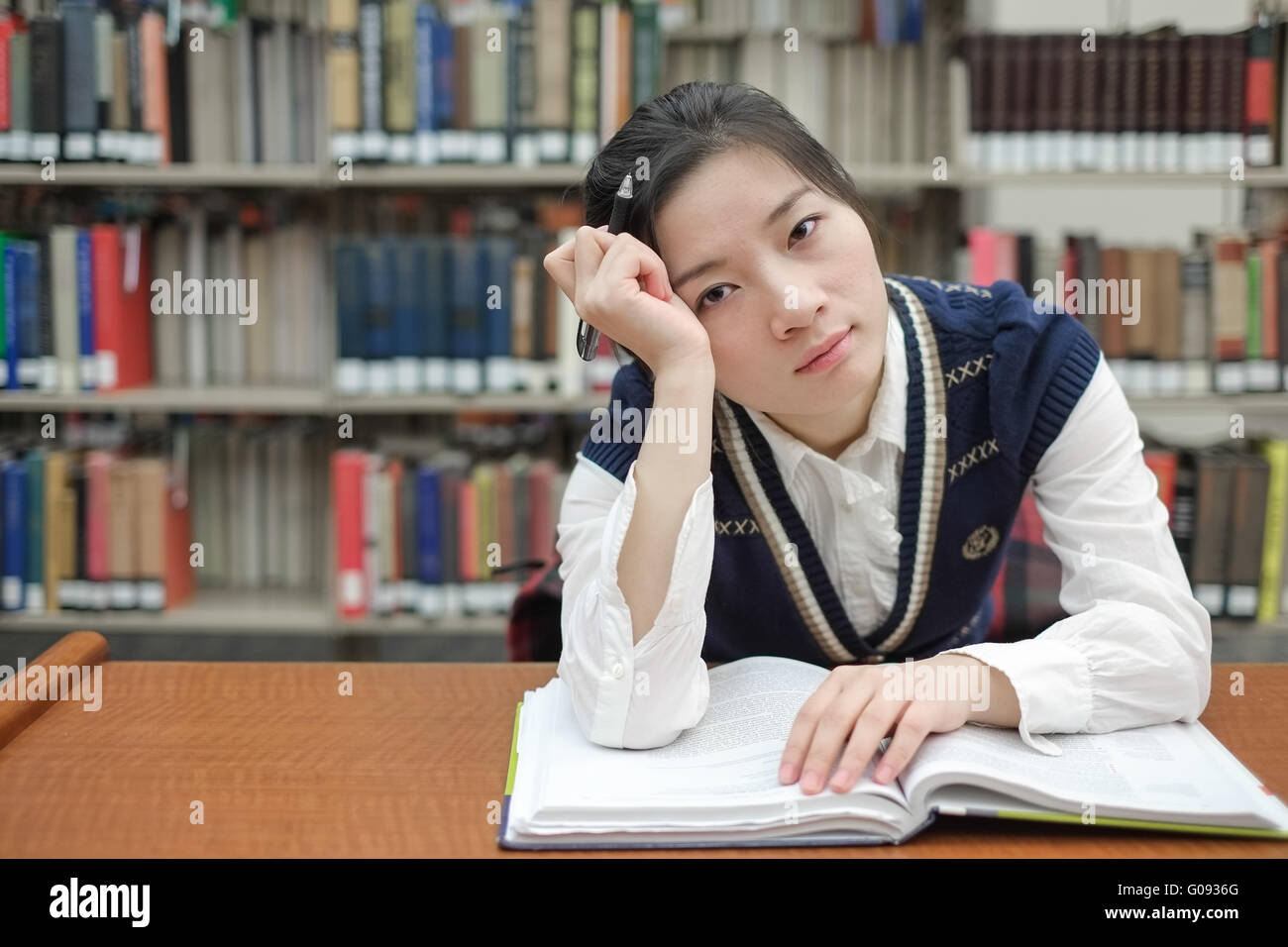 Student with open textbook deep in thought Stock Photo - Alamy