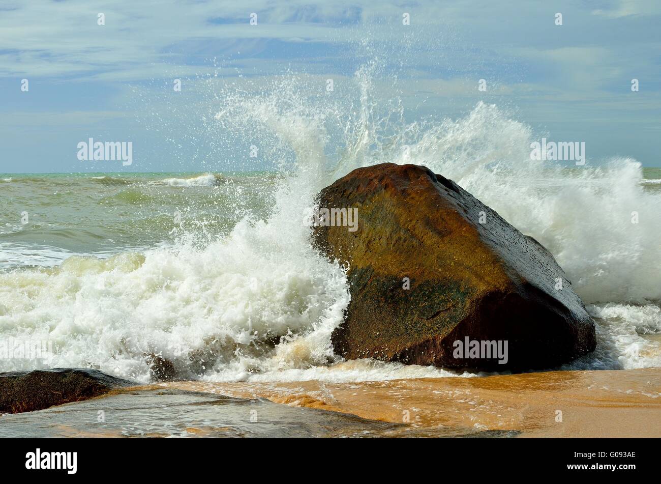 Rock in the surf Stock Photo - Alamy