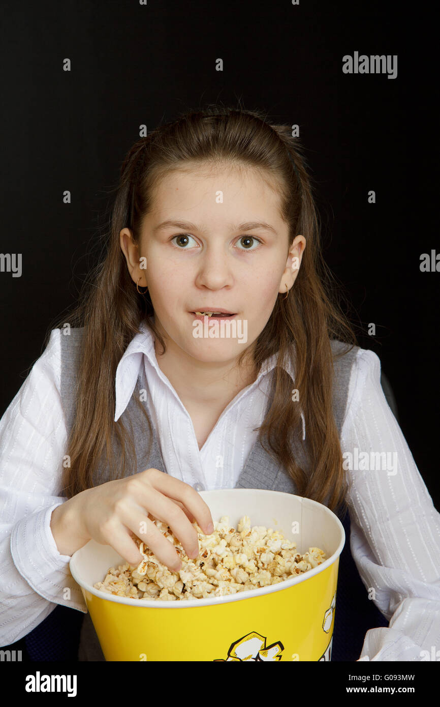 surprised girl with popcorn on a black background Stock Photo - Alamy