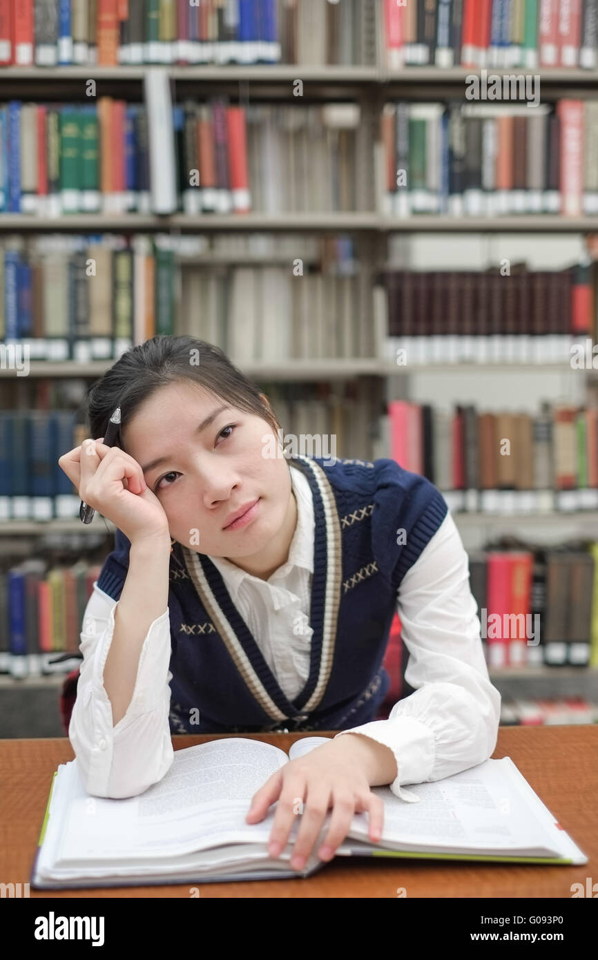 Student with open textbook deep in thought Stock Photo - Alamy