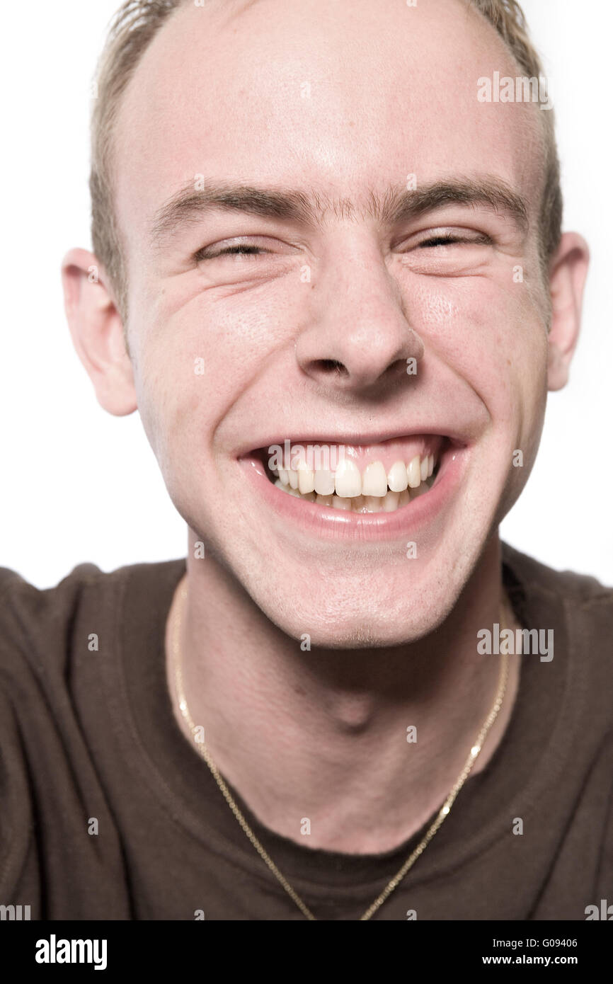 Studio portrait of a young man laughing loud Stock Photo - Alamy
