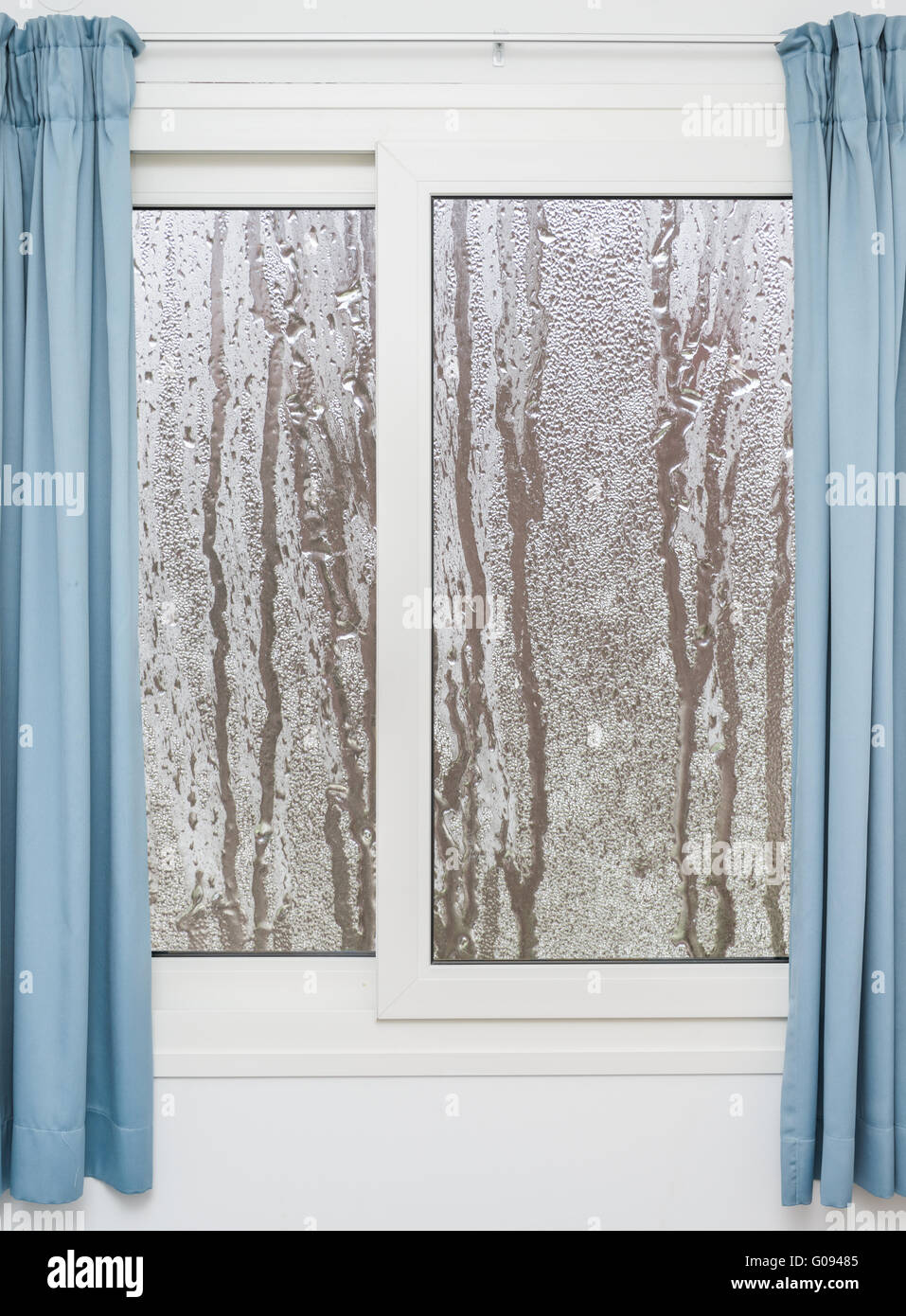 White window with blue curtains on a rainy day Stock Photo - Alamy
