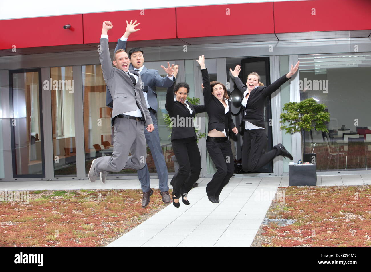 Triumphant business team cheering and celebrating Stock Photo - Alamy