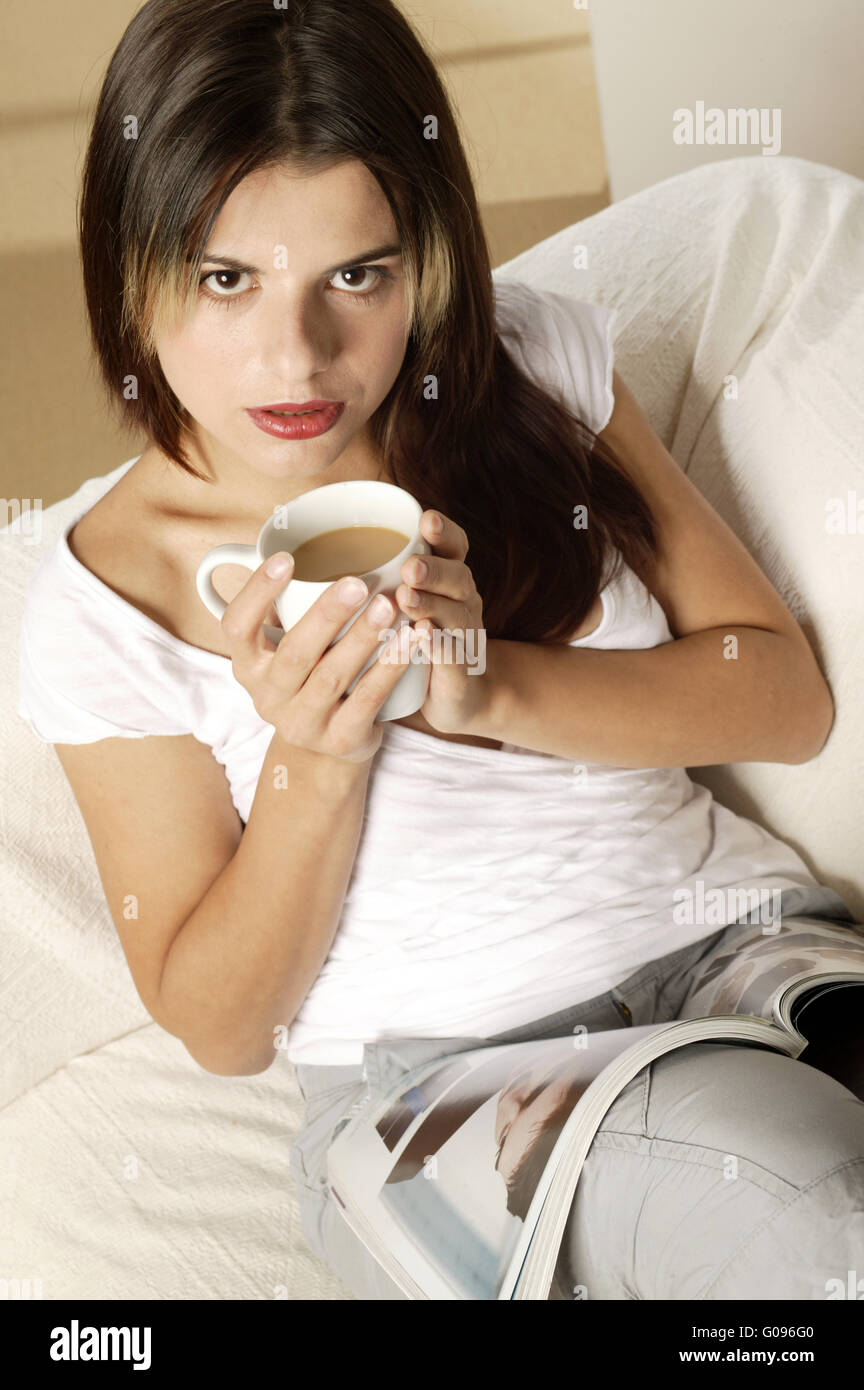 Young woman drinking coffee Stock Photo - Alamy