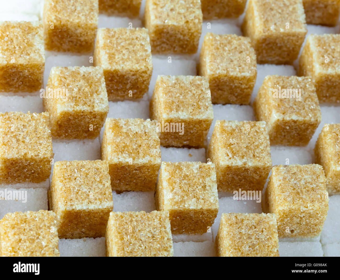 Cubes of not refined reed sugar lie on pieces of w Stock Photo - Alamy