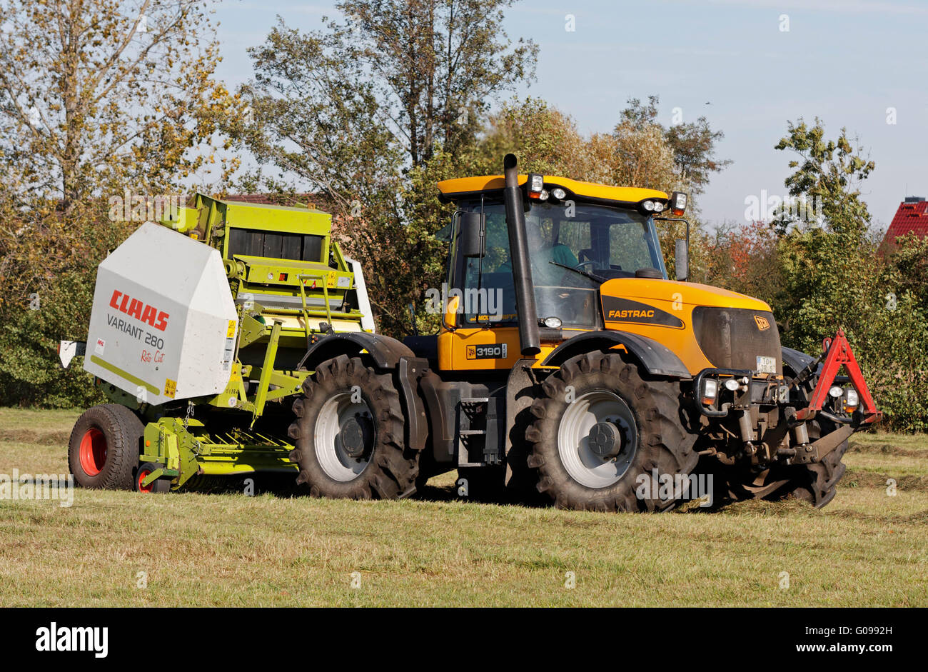 Press tractor with the hay harvest in Dautschen Stock Photo - Alamy